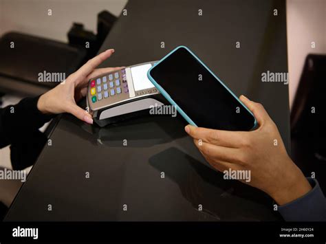 NFC Contactless Payment With Electronic Credit Card In Smartphone And Via POS Terminal Focus On