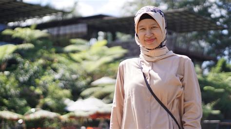 Premium Photo Portrait Of Woman In Hijab Standing Against Plants