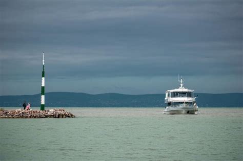 Premium Photo Sailboat On Sea By Building Against Sky