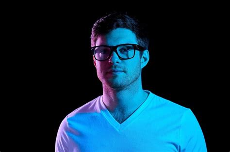 Premium Photo Man In Glasses Over Neon Lights In Dark Room