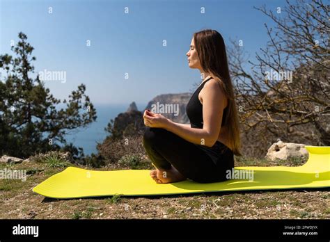 Beautiful Woman Practicing Yoga In The Parkyoga Ardha Padmasana Half