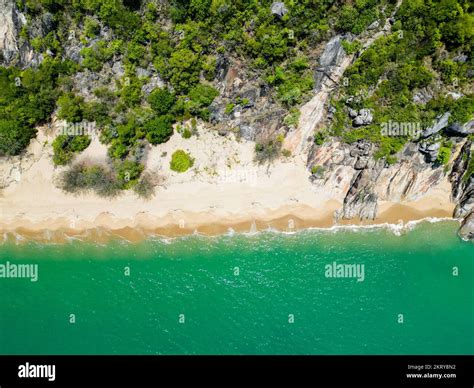 Aerial Down Shot Of Tropicl Beach With Waves Crashing White Sand And
