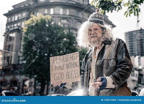 Senior Homeless Man Stacking Coins Stock Image