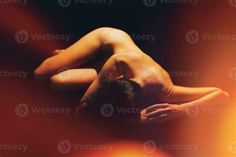 Unrecognizable Female With Naked Body Lying In Black Studio Stock Photo At Vecteezy