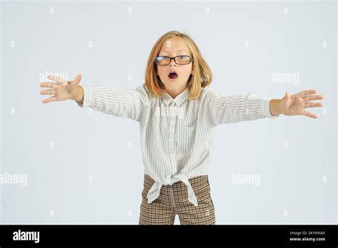 A Teenager Girl Expresses Emotions By Spreading Her Arms And Opening Her Mouth In Surprise
