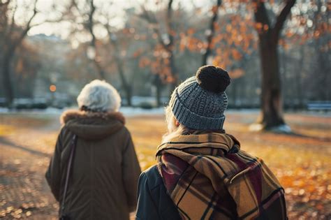 Premium Photo Young Woman And Grandmother Walking At The Park In The