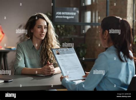 Young Woman Telling About Her Work Experience While Manager Examining