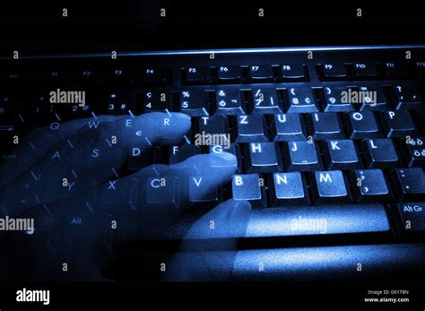 Computer Keyboard With Ghost Fingers At Night Stock Photo Alamy
