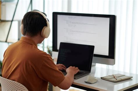Premium Photo Developer Wearing Headphones When Testing New Software