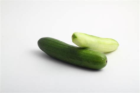 Premium Photo Whole Peeled And Unpeeled Fresh Cucumber On White