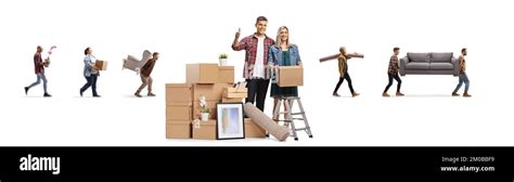 Happy Young Couple With Removal Boxes And People Carrying Items Behind