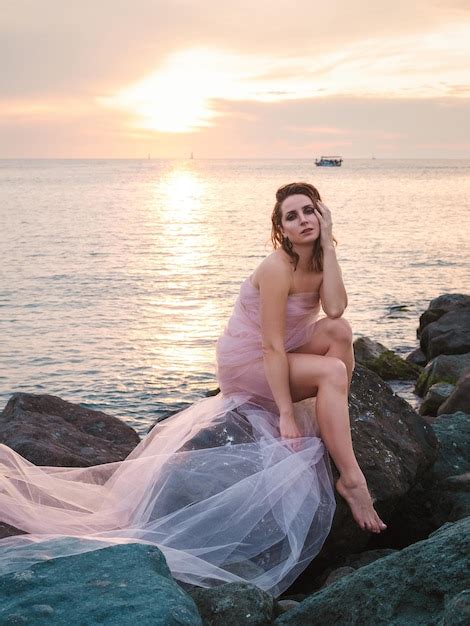 Premium Photo Sexy Blonde Woman Wrapped In Pink Tulle Fabric Sits On