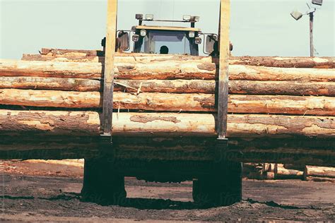 Wheeled Log Front Loader Carrying Tree Trunks By Stocksy Contributor