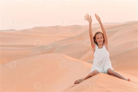Girl Among Dunes In Rub Al Khali Desert In United Arab Emirates