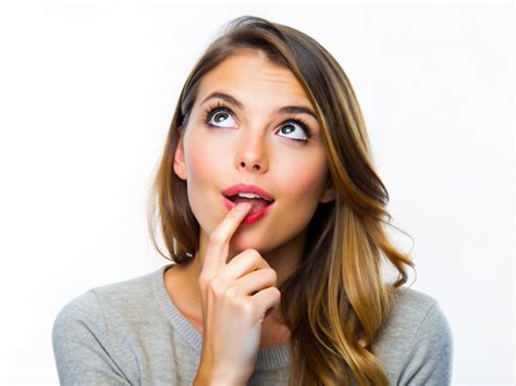 A Young Women Making A Curious Face With Her Tongue Out And Hand On Her
