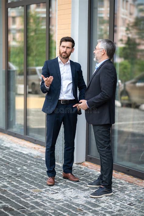 Two Elegant Men Talking And Looking Interested Stock Image Image Of