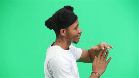 A Man Close Up On A Green Background Shows A Pause Sign Stock Image