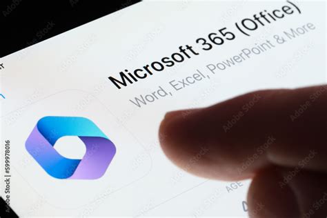 Microsoft 365 Office App Seen In App Store On The Screen Of Ipad And Blurred Finger Pointing At