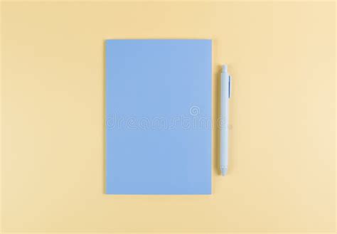 Top View Of Blue Notebook Blue Pen On Yellow Background School
