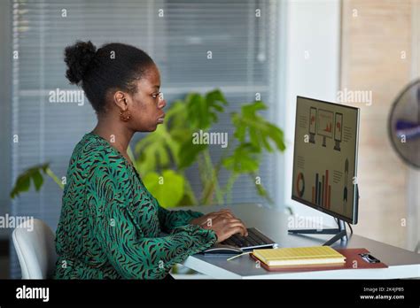 Young Analyst Or Creative Designer Looking Through Graphic Information
