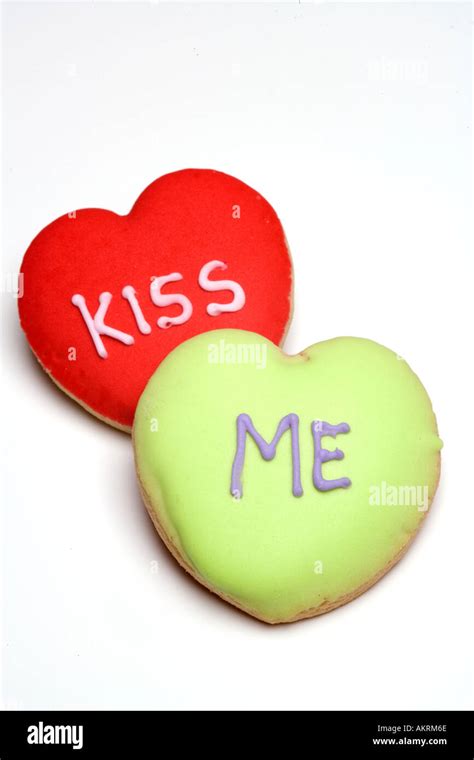 Two Red And Green Frosted Heart Shaped Cookies Or Biscuits With Kiss Me