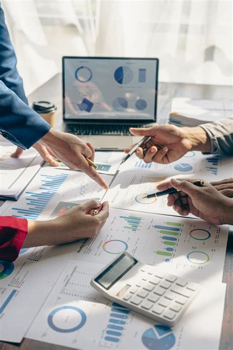 Diverse Colleagues Brainstorm To Discuss Financial Statistics At An