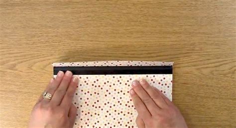 Push Down On The Middle Of The Binding And Roll The Book Toward You As