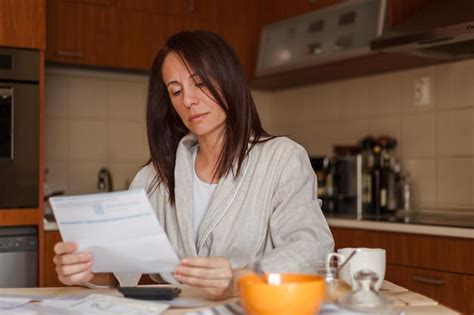 Premium Photo Woman Reading Document While Having Breakfast At Home