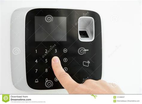Young Woman Entering Code On Alarm System Keypad Stock Image Image Of