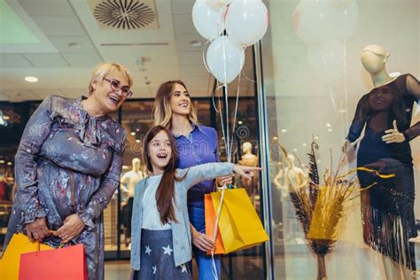 Mother Adult Daughter And Granddaughter In Shopping Mall Stock Image