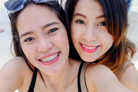 Premium Photo Portrait Of Sisters Smiling