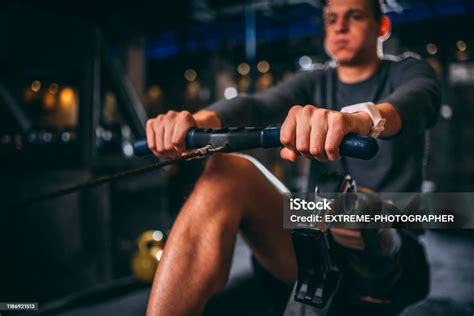 Young Handicapped Athlete With A Prosthetic Doing A Rowing Exercise In