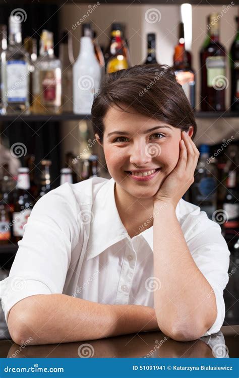 Sexy Female Bartender Pours Green Liquor From Bottle Into Jigger Stock