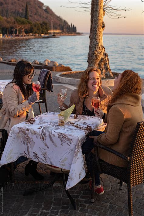 Beautiful Young Women Chilling Together By The Lake By Stocksy