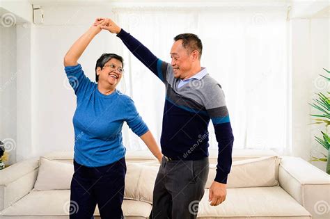 Happy Senior Man And Woman Dancing Together At Home Happy Senior Married Couple Spending Time