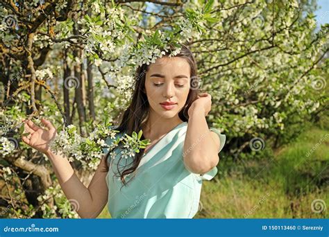 Beautiful Young Woman Near Blossoming Tree On Sunny Spring Day Stock