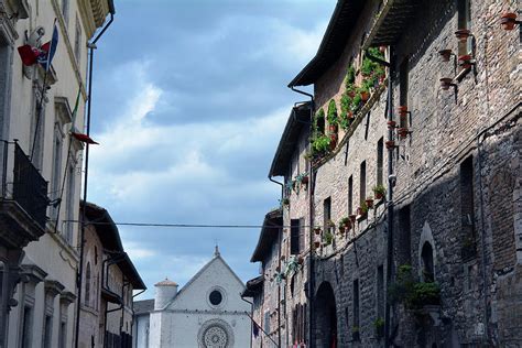 Beautiful Street In Assisi Italy With Stone Buildings And Church