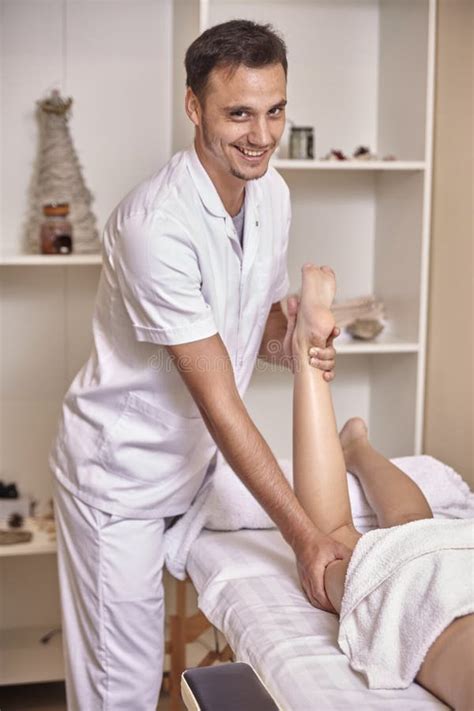 One Young Physiotherapist Man Portrait Worker Massage Woman Legs Stock