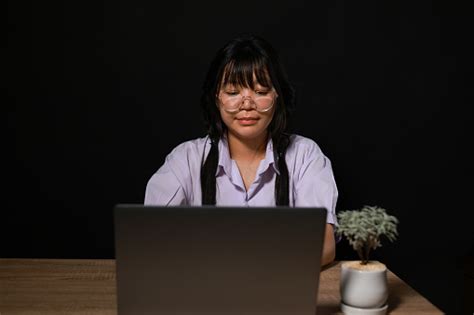 An Asian Girl Homeschooling Task Assign During Night Time The Schoolgirl Type And Uses Digital