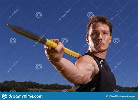 This Is Going The Distance A Lone Man Throwing A Javelin Outside