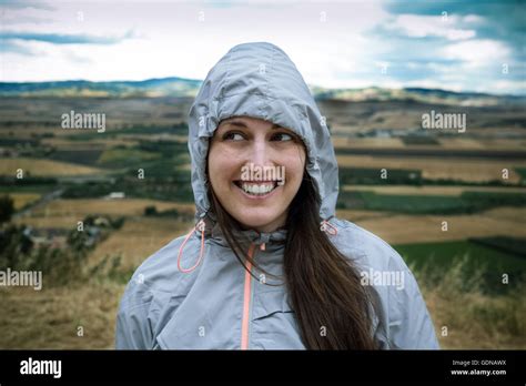 Young Woman Smiling After A Long Hike In Windy Weather Looking Away