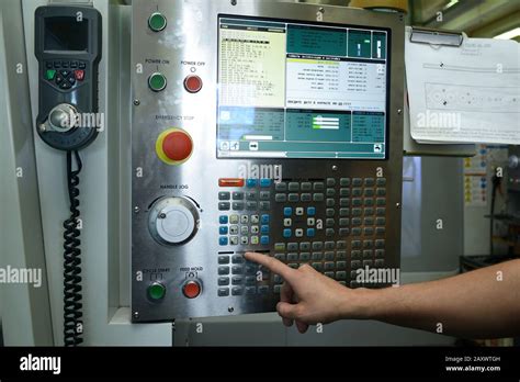 Worker Hands Touching The Button On The Board Of Computer Numerical