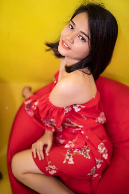 Premium Photo Portrait Of Young Woman Sitting On Bean Bag At Home