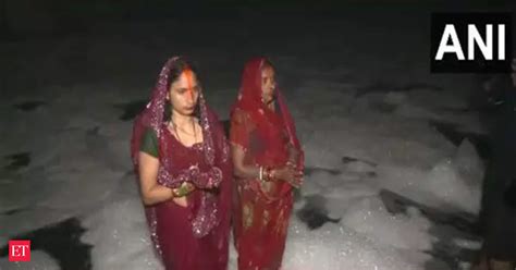 Chhath Puja Delhi Devotees Stand In Knee Deep Toxic Foam In Yamuna