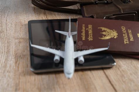 Small Plane Model Thai Passport Leather Bag Tablet On Wooden Board