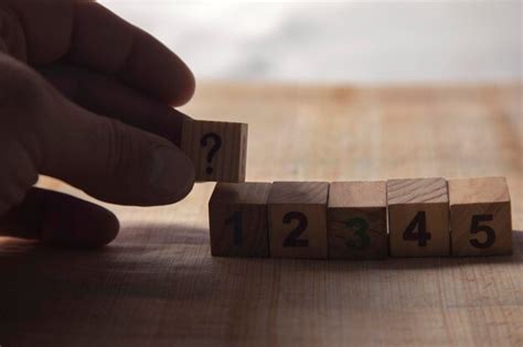 Premium Photo Man Arranges The Number Wood Cubes