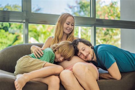 Expectant Parents Mom Dad And Their Eldest Son Share A Heartwarming