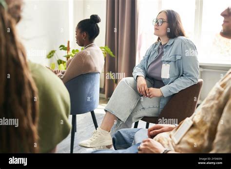 Diverse Group Of People Sitting In Modern Classroom Engaging In