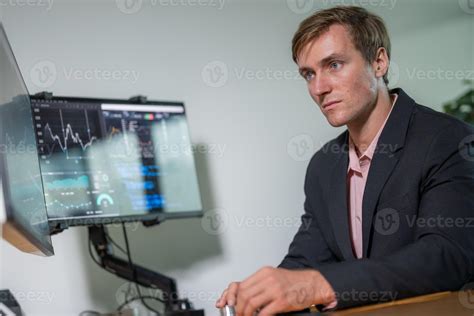 Professional Man Analyzing Data On A Computer Screen In A Modern Office
