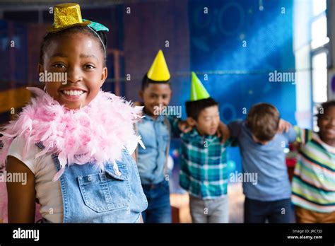 Portrait Of Girl Wearing Feather Boa With Friends In Background During